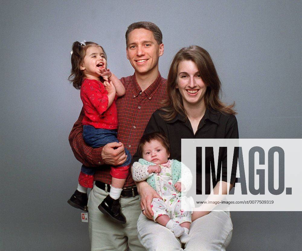 Eric Rowlee center holds his daughter 19 month old Belle Rowlee while ...