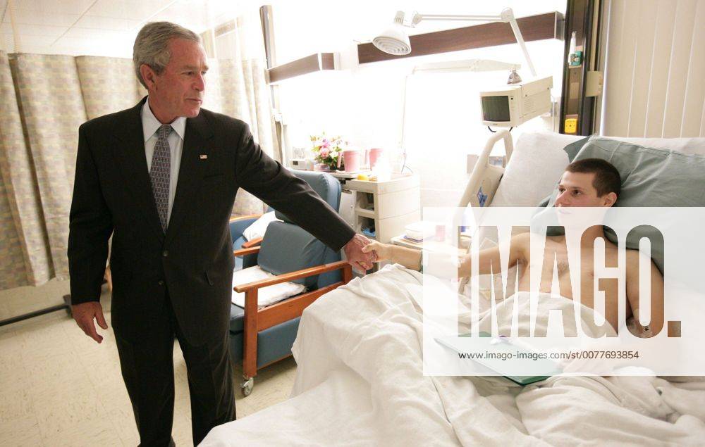 U.S. - President George W. Bush reaches back for the hand of Army ...