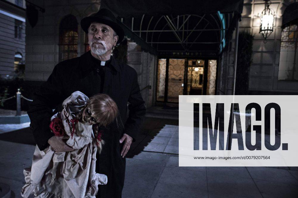 TONY AMENDOLA as Father Perez with the Annabelle doll in New Line ...