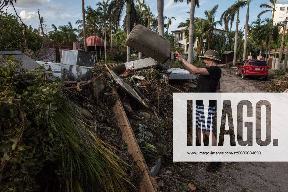 Mark Grafton, throws away damaged items from his flooded house after ...