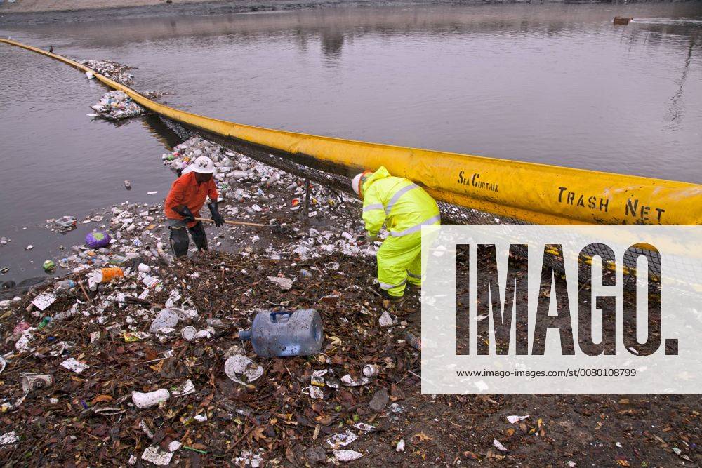 Department of Public Works workers clean up garbage that accumulates in ...