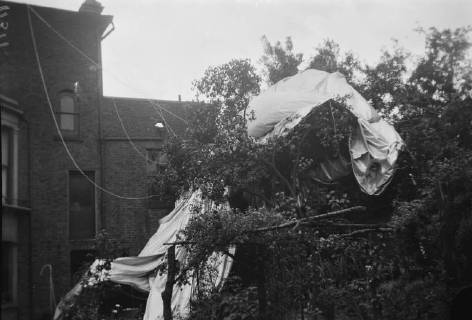The aftermath following a barrage balloon explosion . The balloon lies ...