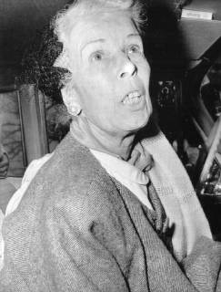 Mildred E Gillars, known as Axis Sally during World War II, is shown relaxing on the porch of the