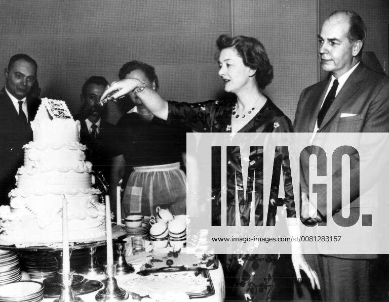As her husband Howland H. Sargent (right) looks on, actress Myrna Loy ...