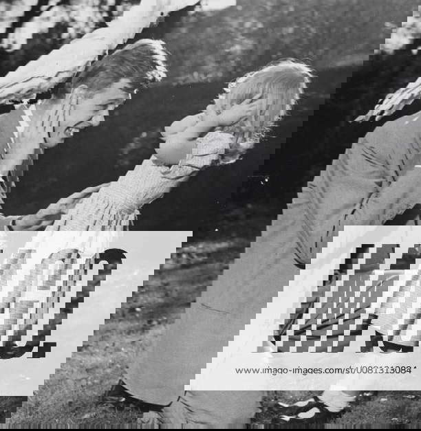 Three-year-old Susan and her father David Attenborough cover their ears ...