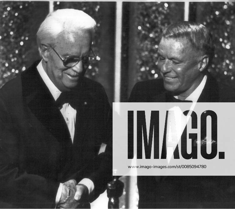 HOLLYWOOD -- --FRANK SINATRA (R)CONGRATULATES M.J. FRANKOVICH WHO WAS ...