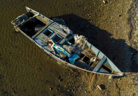 VLADIVOSTOK, RUSSIA - : Model Anastasia Slobodchikova poses wearing a mermaid tail costume on