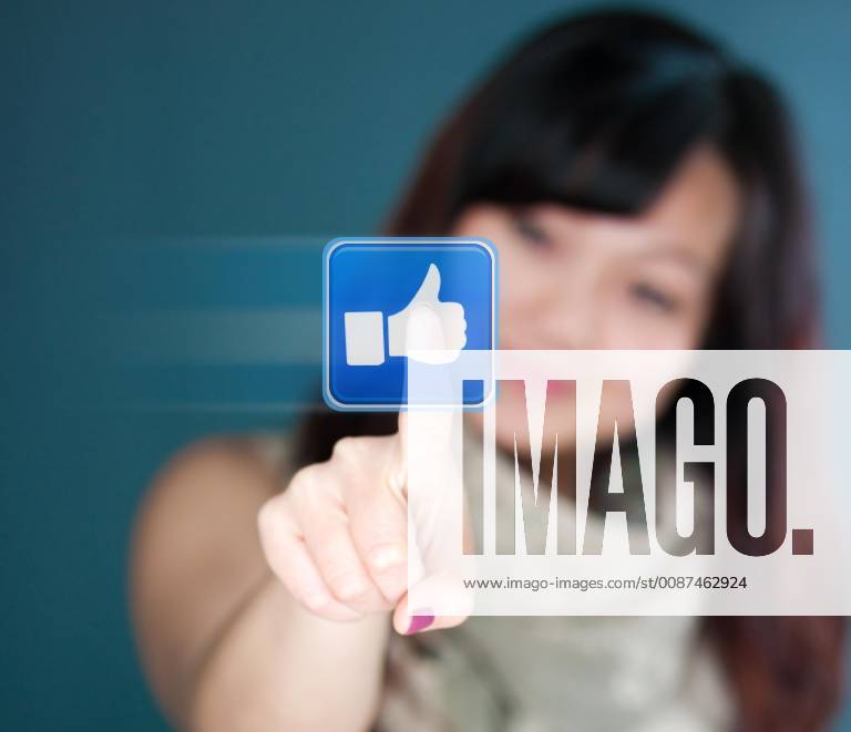 Cute young woman is touching the like button model released Symbolfoto Y
