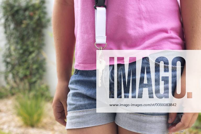 Girl wearing key around her neck, cropped