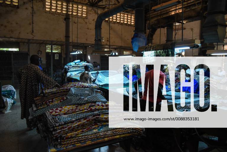 Segou, Mali. Workers check the final quality of the loincloth fabrics ...