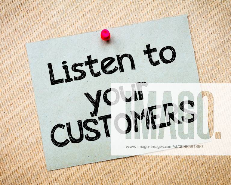 Listen to your customers Message. Recycled paper note pinned on cork ...