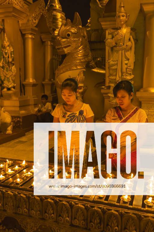 Yangon Girls Myanmar, Yangon. Young Girls Light Oil Lamps And Offer