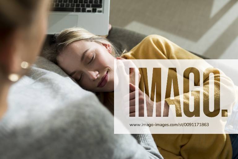 Affectionate Lesbian Couple Cuddling On The Sofa Model Released