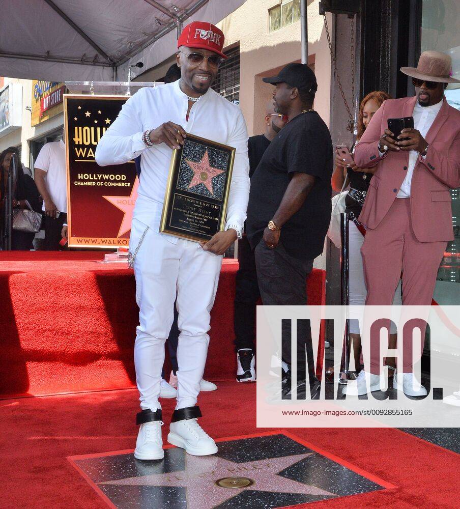 Recording artist and music producer Teddy Riley holds a replica plaque ...