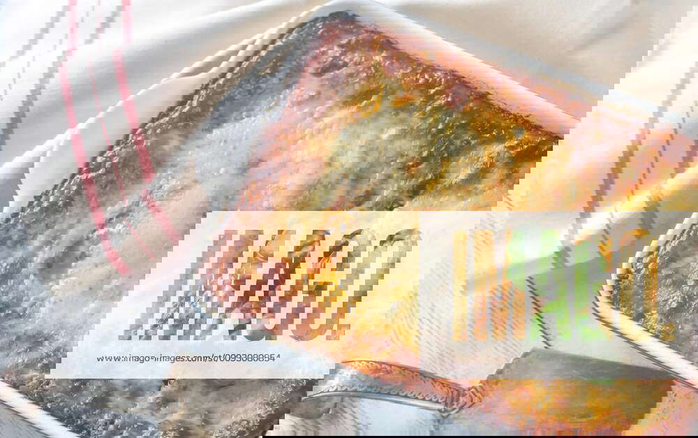 Dish of lasagne on the wooden table