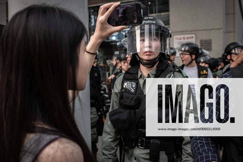 September 7, 2019, Hong Kong, Hong Kong, China: A woman films a group ...