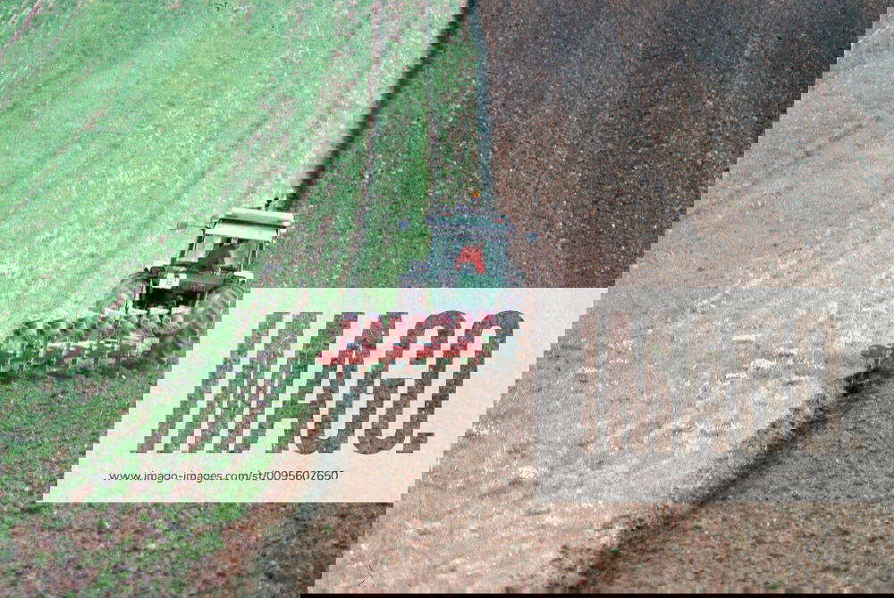 Agriculture in the 80s Farmer ploughing his field on his tractor ...