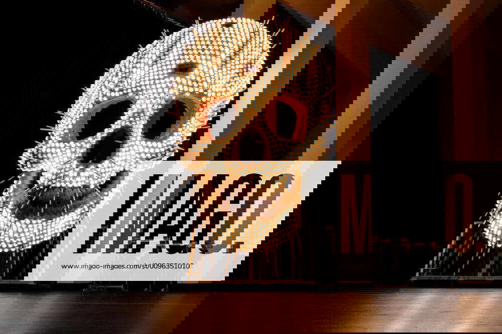 An oversized skull illuminated by many light bulbs from the play ...