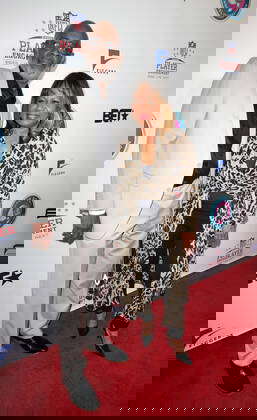 Marcus A. Riggins and Brenda L. Hill Riggins walk the red carpet during ...