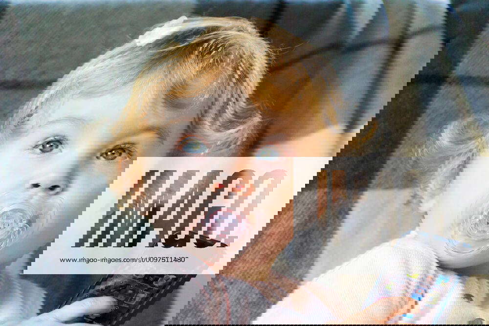 Cute infant with cellular Cute baby girl with new mobile phone Y