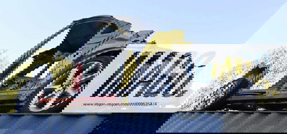 A dismantled passenger car is standing on a container on the premises ...