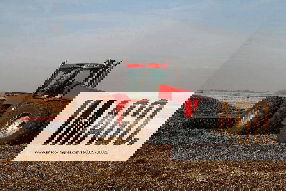 Tractor and harrow Tractor and harrow on the field Y