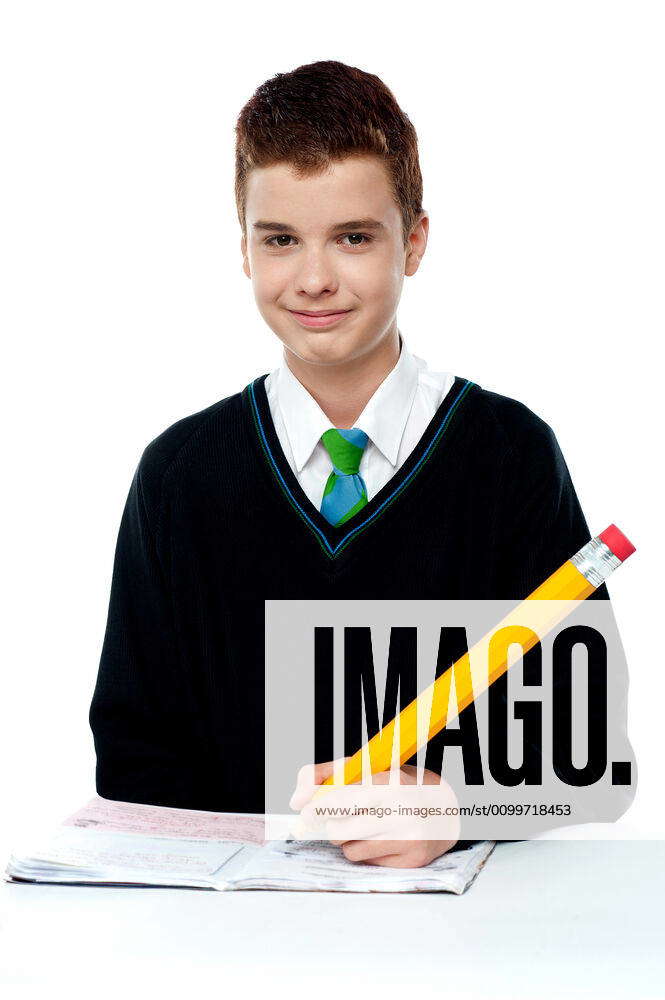 School boy writing on notebook School boy writing on notebook with big ...