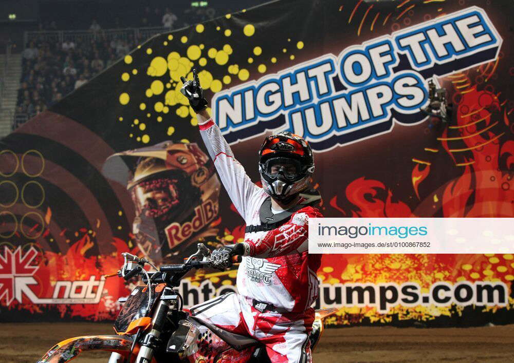 19 Feature Night of the Jumps, A rider makes the Peace sign in front of ...