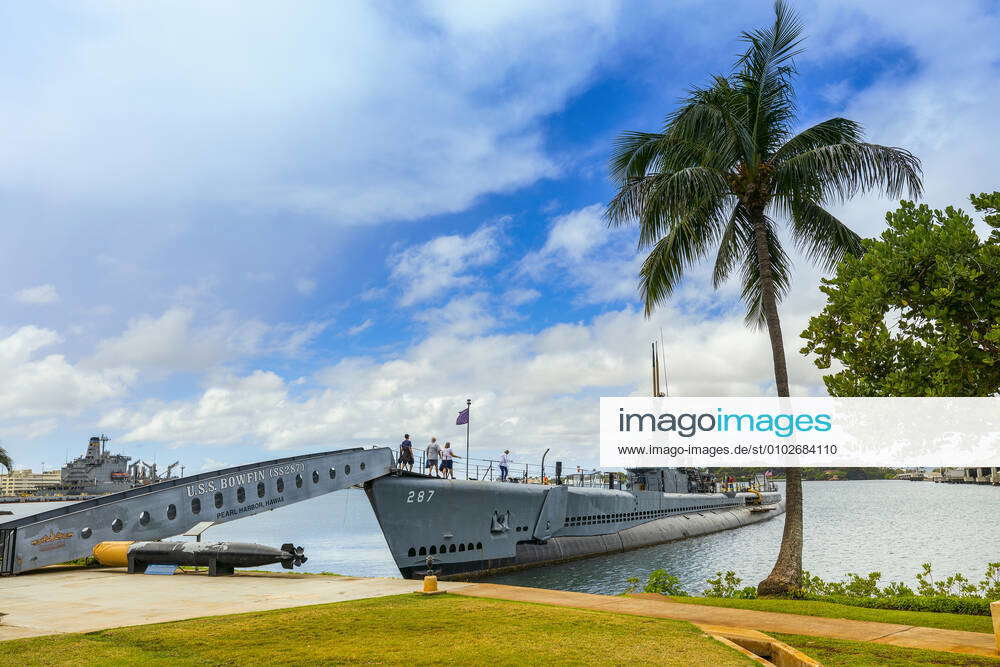 Torpedo display and tourists exploring a submarine at Pearl Harbour ...