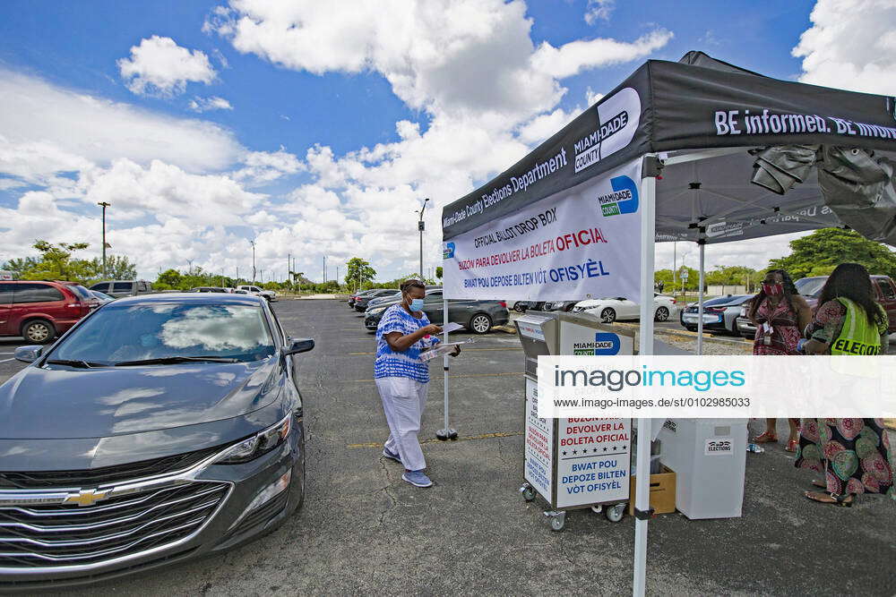 August 9, 2020, Miami, FL, USA: A poll worker walks off after ...