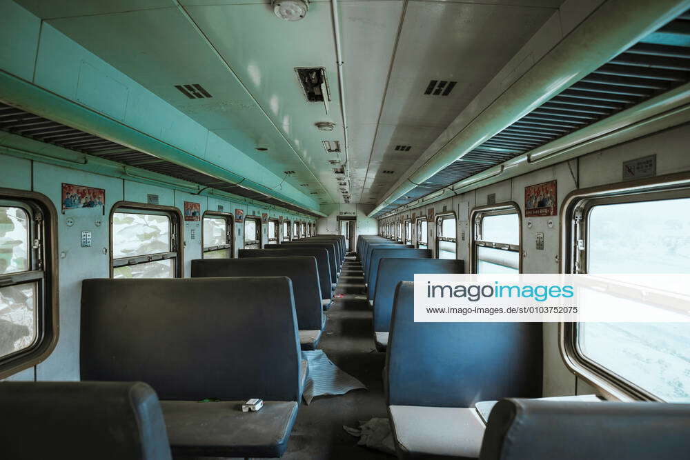The interior scene of an abandoned green-skinned train