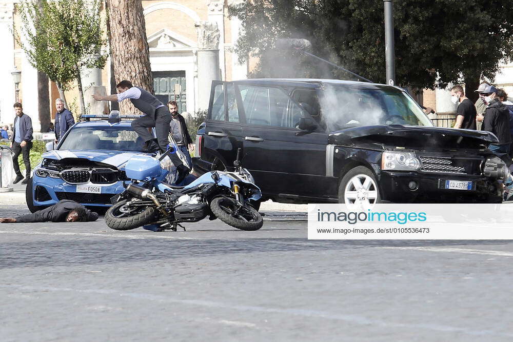 Actor Tom Cruise jumps on a police car while acting on the set of the ...