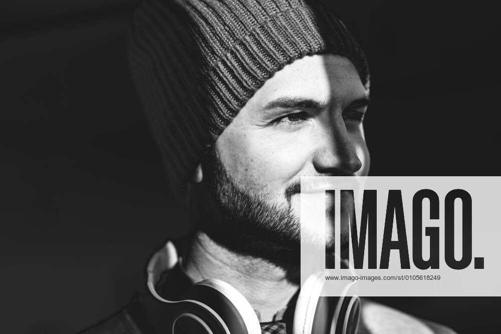 Smiling young man with wooly hat model released Symbolfoto