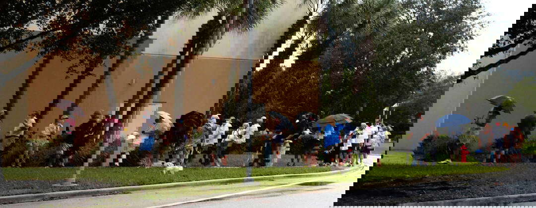 Palm Beach county residents wait in line for over 2 hours in heavy rain ...