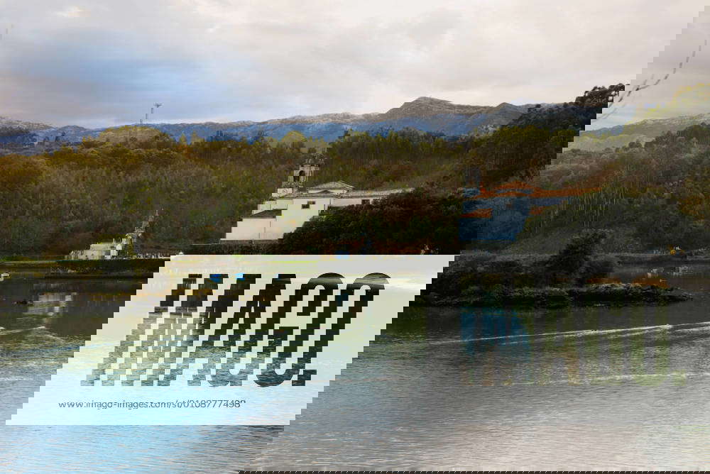 Picturesque view on beautiful lake and building on coast near trees in ...