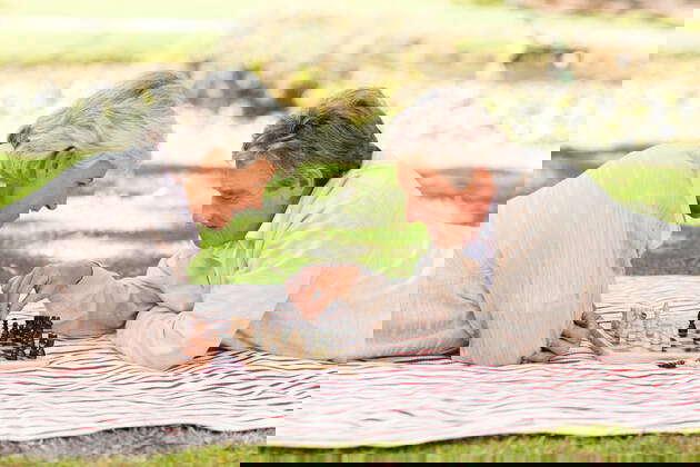 Elderly couple playing chess Elderly couple playing chess in a park ...