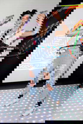 Fata Hasanovic dances with a hula hoop at the big 90s neon bash at ...