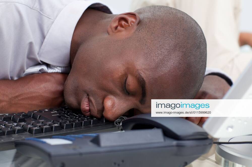 Businessman sleeping on the keyboard Businessman sleeping on the ...