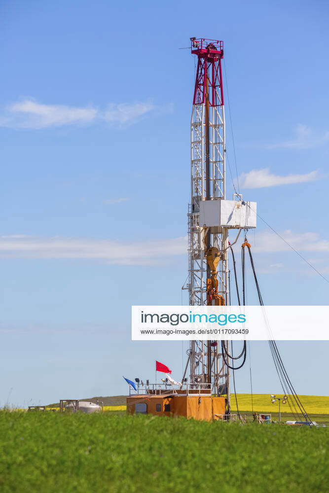 Triple rig drilling equipment at the site of an oil well; Alberta