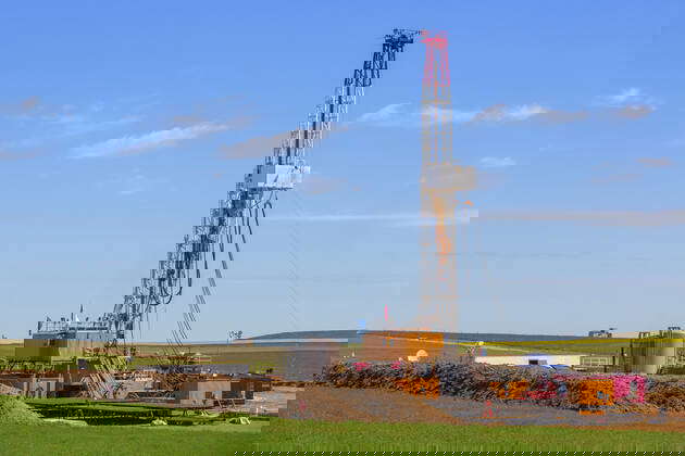 Triple rig drilling equipment at the site of an oil well; Alberta