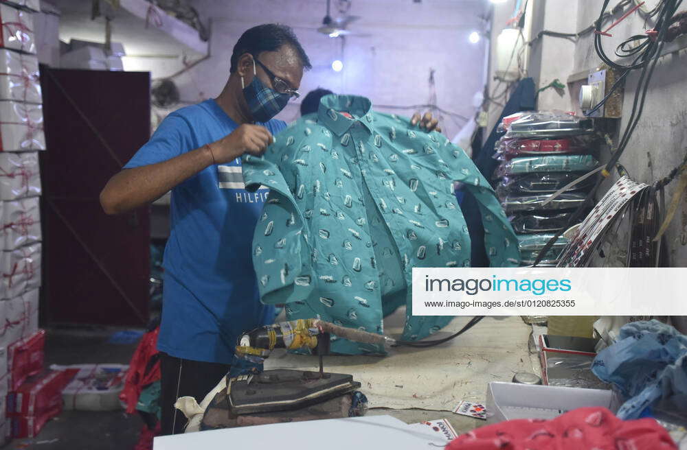 NEW DELHI, INDIA - JUNE 8: Labour working a cloth factory following ...