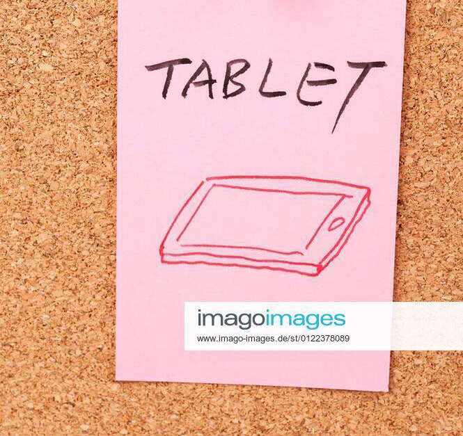 Tablet word and symbol drawn on paper and pinned on cork board ...