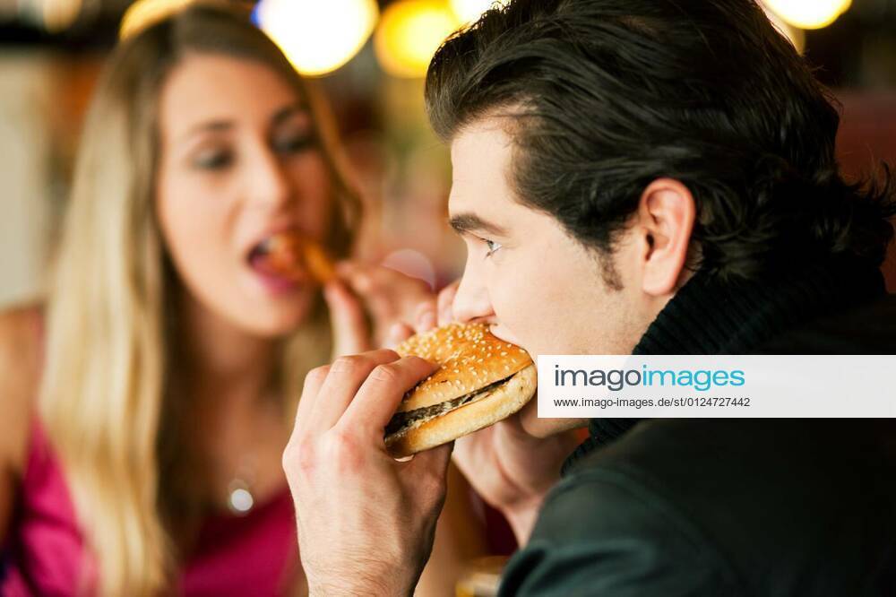 Couple in restaurant eating fast food model released ...