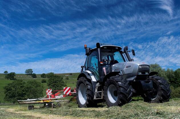 Rowing up grass for silage using a Pottinger rake pulled by a Hurlimann ...