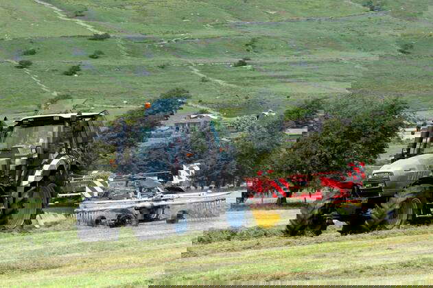 Rowing up grass for silage using a Pottinger rake pulled by a Hurlimann ...