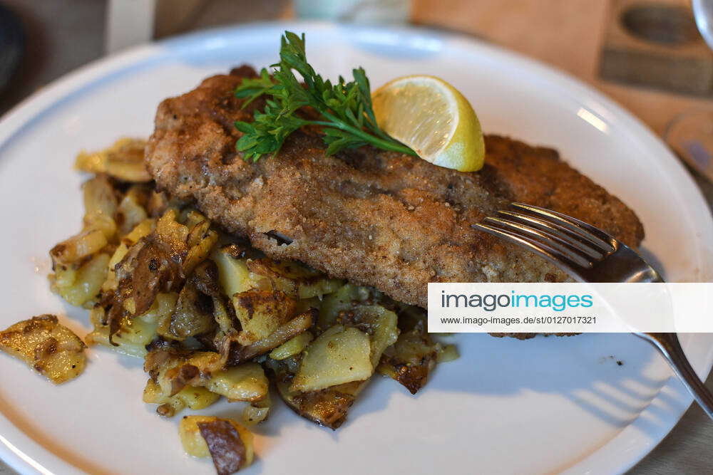 Cordon bleu with fried potatoes and lemon Kitchen classic served in an ...