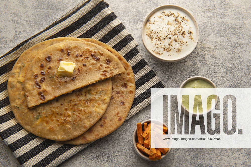 STUFFED PARANTHAS WITH BUTTER ON TOP SERVED WITH APPETIZERS SLZH