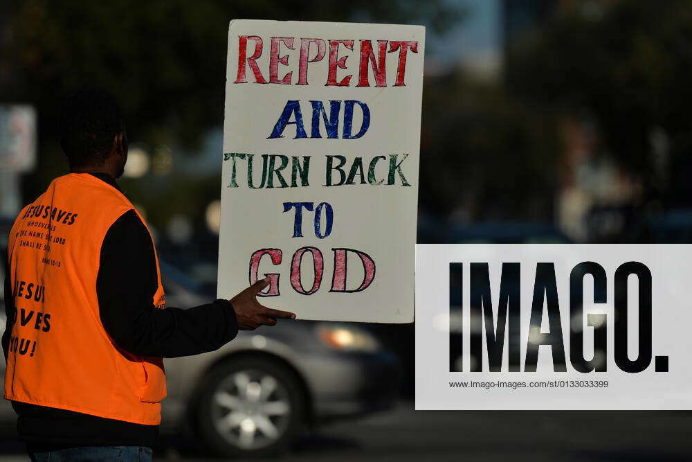 Edmonton Pride Corner Protest A street preacher holds a placard that ...