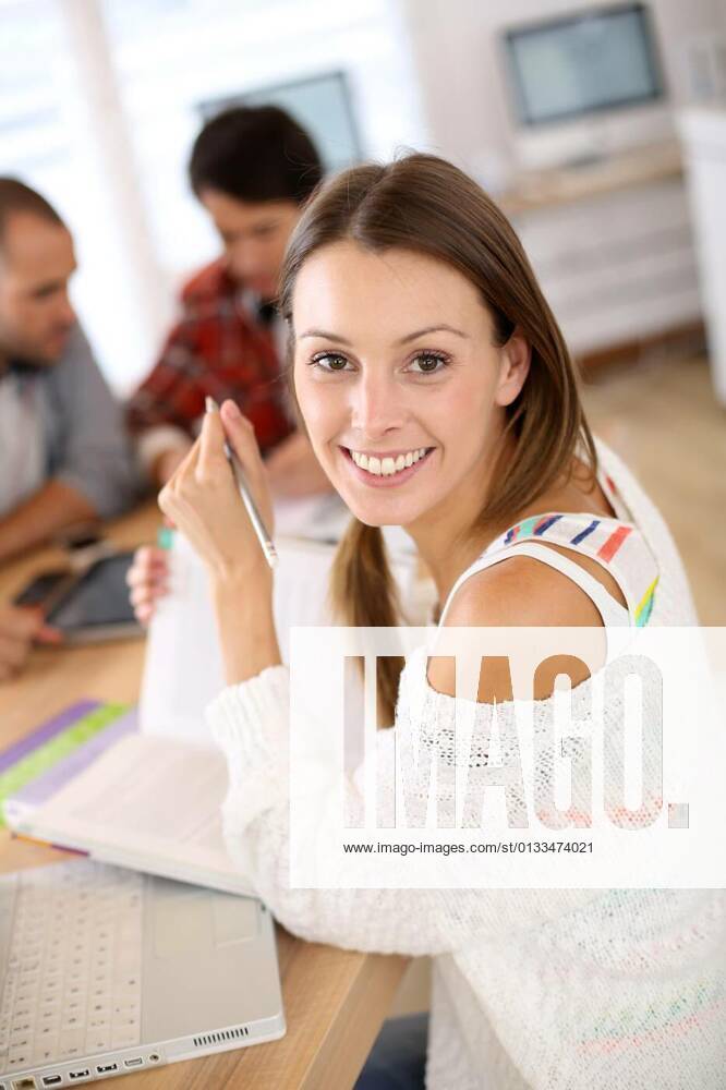 Girl in class studying with laptop and school book model released ...