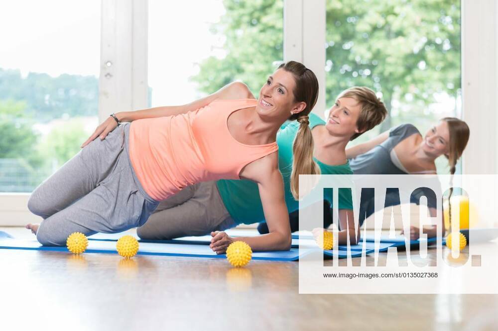 Women doing exercises for pelvis floor in postnatal regression course ...